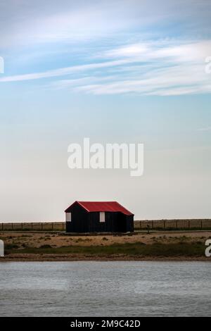 Red roof fishing hut in Rye Harbour Nature Reserve. East Sussex ...