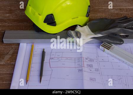 work table where there are drawings of land plans and building projects ...