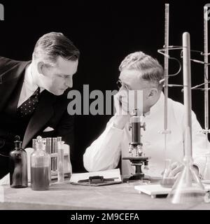 Middle age man wearing scientist uniform using microscope at laboratory ...