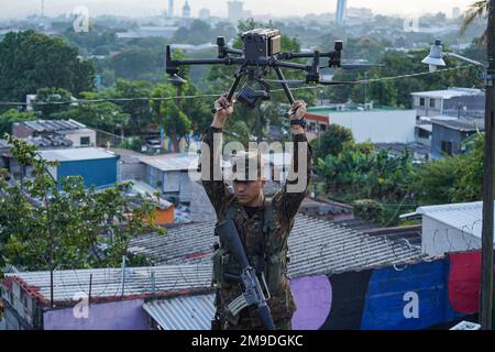 A soldier lifts up a drone during the inauguration of a community ...