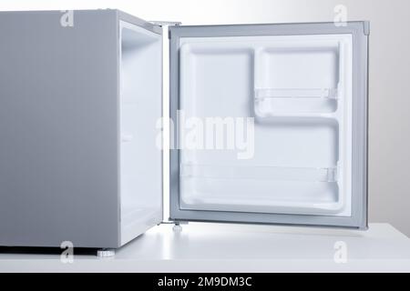 Opened mini fridge, minibar refrigerator isolated over white background ...