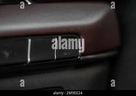 Hand operating ESP (electronic stability program) control close up view ...