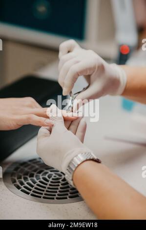 A closeup shot of the nail master working on the client's nails Stock ...