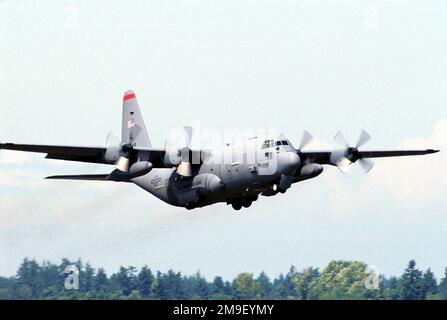 A right front view of a C-130 Hercules aircraft airdropping cargo using ...