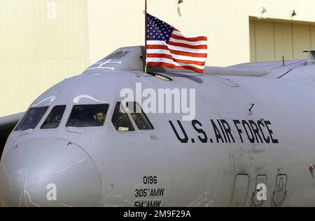 An air-to-air left side view of a C-141 Starlifter aircraft in a ...