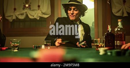 A group of mobsters gather around a table in a dimly lit nightclub. One ...