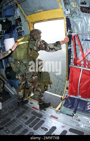 A jumpmaster from the 173rd Airborne Brigade gives jump commands as ...