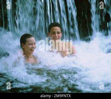 Couple of young latin men in black pants, shirtless with neckties with ...