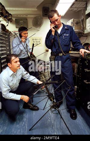 US Navy Electronics Technician Third Class performs maintenance on the ...