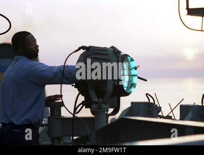 Signalman Second Class Kevin Lewis signals to USNS Concord (T-AFS 5 ...