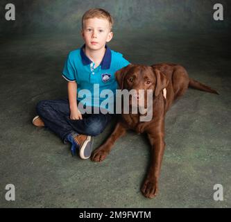 Portrait of boy with Chocolate Labrador Stock Photo - Alamy