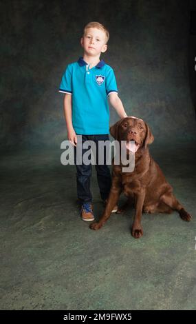 Portrait of boy with Chocolate Labrador Stock Photo - Alamy
