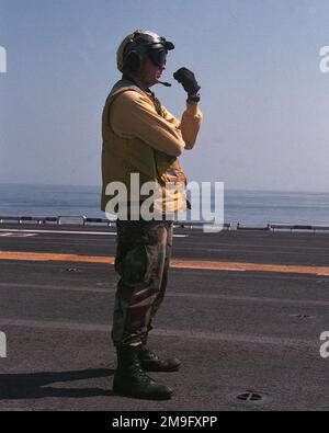 A US Navy Sailor directs traffic aboard the USS TARAWA (LHA 1) during ...