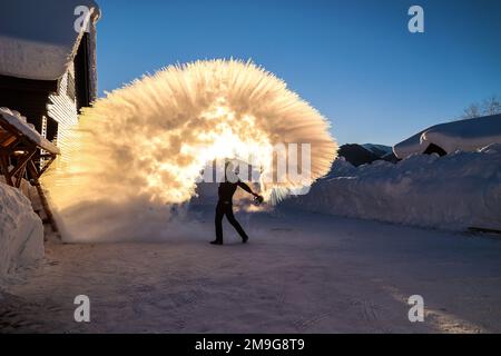 ALTAY, CHINA - JANUARY 18, 2023 - Police officers enjoy pouring water ...