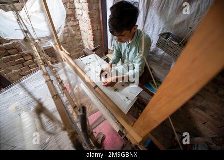 Weaver producing woolen shawls on a handloom, Islampur, Swat Valley ...