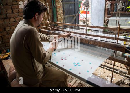 Weaver producing woolen shawls on a handloom, Islampur, Swat Valley ...