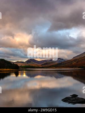 Perfect reflection of snow covered Snowdon Horseshoe mountains in a ...
