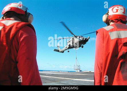 US Navy Aviation Ordnancemen (AO) Edward Green, (left) AO David Butts ...