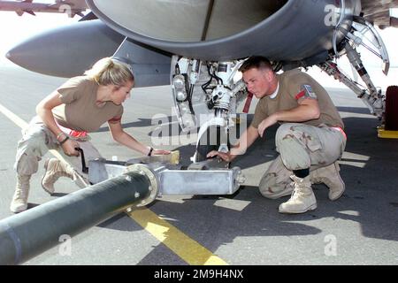 AIRMAN First Class (A1C) Danicka Jensen, a Crew CHIEF, kicks the tire ...