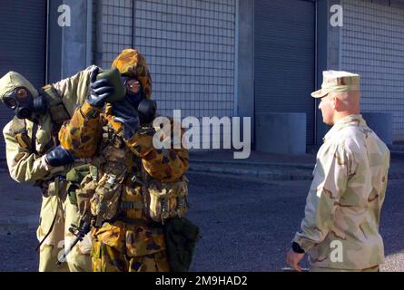A Marine successfully gets a drink of water from his canteen while in ...