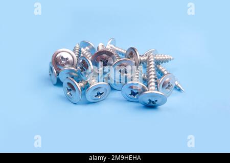 screws a lot, macro photo. Long Iron or metal screw nails on red ...