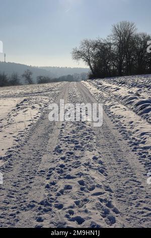 Lanes on a dirt road in Heckengaeu near Weissach in winter Stock Photo ...