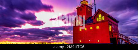 A low light view of the lighthouse at dusk on Ynys Llanddwyn on ...