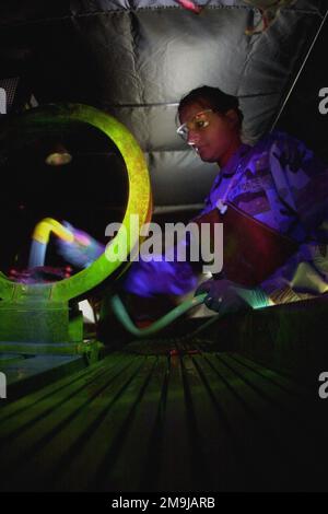 A U.S. Air Force non-destructive inspection technician reviews ...