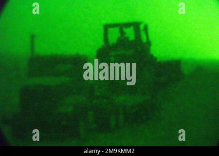 A US Navy (USN) Seabees earthmoving Caterpillar bulldozer begins ...