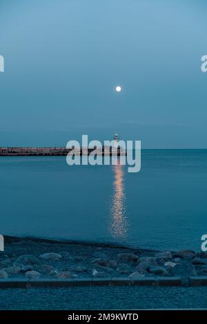 The full moon rises to the lighthouse, the moon path is not the Stock ...