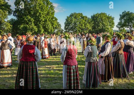 People in folk costumes and herbal wreaths celebrate Midsummer in ...