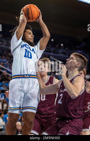 UCLA guard Tyger Campbell, left, takes the ball down the court during ...
