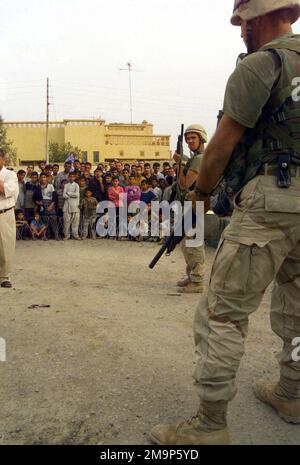 Iraqi security forces stand guard as they check motorists entering the ...