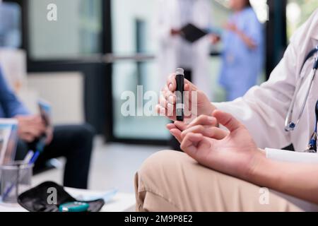 Elderly medic measuring insulin level and glucose using glucometer ...