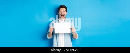 Excited man making fantastic announcement, showing logo or sign on ...
