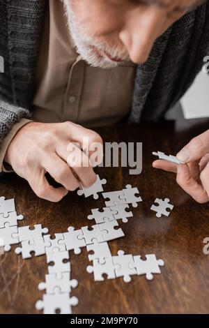 cropped view of man with parkinson disease holding glass of water near ...