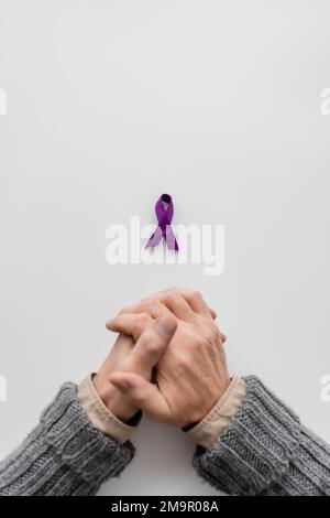 cropped view of aged man with alzheimer disease writing on sticky notes ...