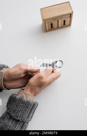cropped view of senior man with parkinson disease and tremor in hands ...