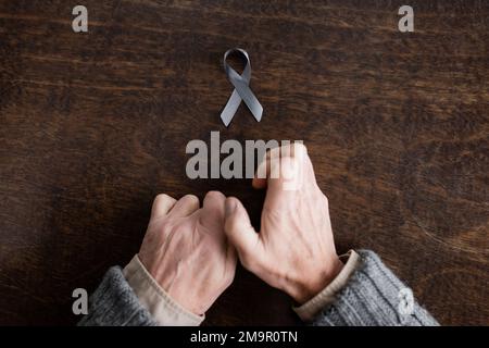 top view of cropped man with trembling hands suffering from parkinson ...