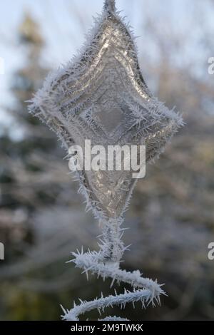 Frost covering a hanging, decorative garden ornament Stock Photo - Alamy