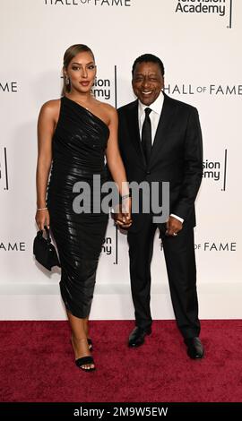 Samira Baraki, left, and inductee Robert L. Johnson walk the red carpet ...