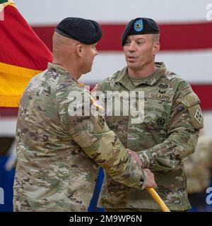 Col. Damon Wells, commander of 4th Infantry Division Artillery, hands over the battalion colors ...