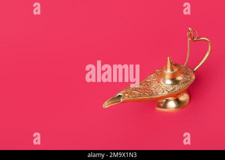 Aladdin lamp of wishes for Ramadan on table against dark yellow ...