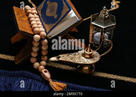 Aladdin lamp, Muslim lantern, Koran and prayer beads for Ramadan on mat ...