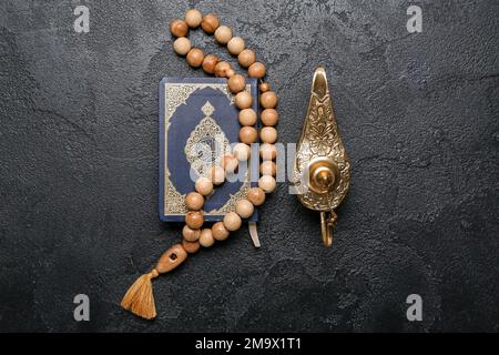 Aladdin lamp of wishes, Koran and prayer beads for Ramadan on blue ...