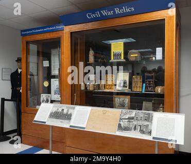 A display of Civil War relics including tattered flags, a sword ...