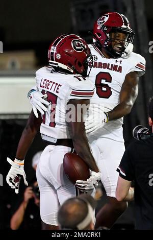South Carolina wide receiver Xavier Legette (17) tries to get away from ...