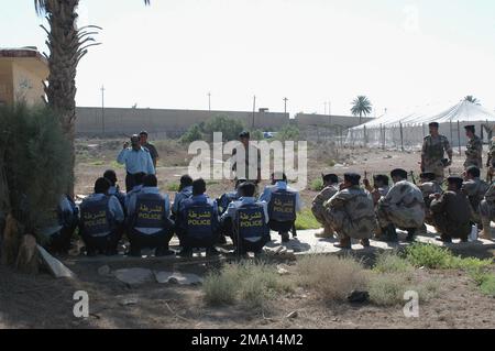 U.S. Marine Corps officers listen to a mission brief at Camp Barrett ...