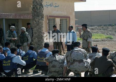 U.S. Marine Corps officers listen to a mission brief at Camp Barrett ...