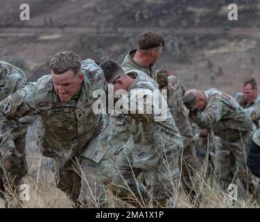 Soldiers at Fort Carson, Colorado help each other climb a container ...
